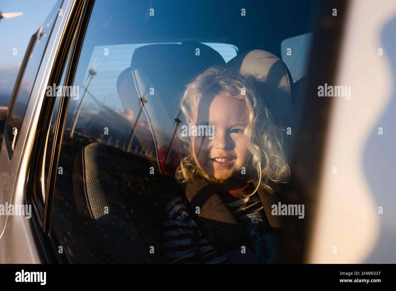 Smiling boy looking through window in car Stock Photo - Alamy
