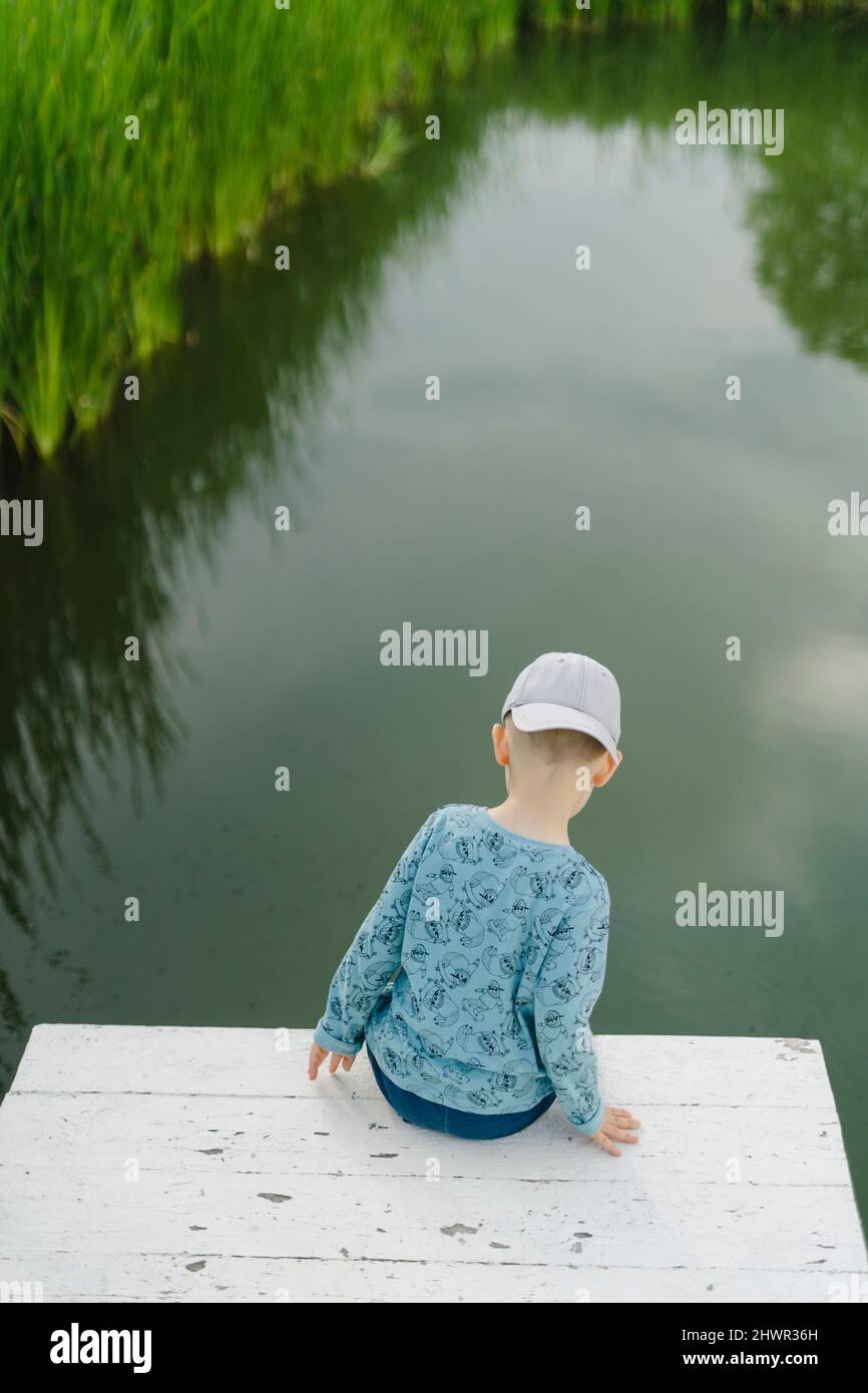 Boy on jetty hi-res stock photography and images - Alamy