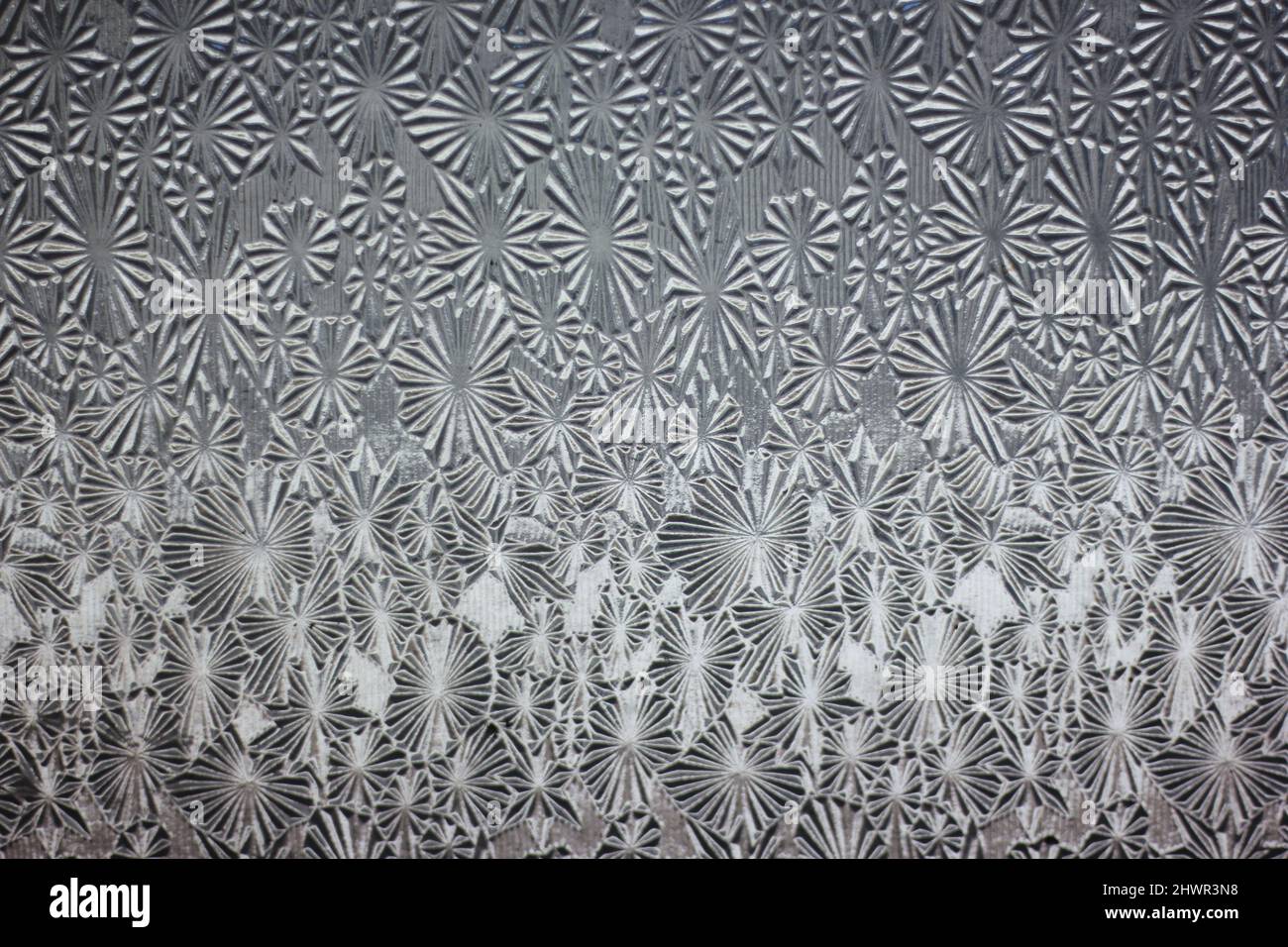 Interesting texture of an antique glass window with a floral pattern ...