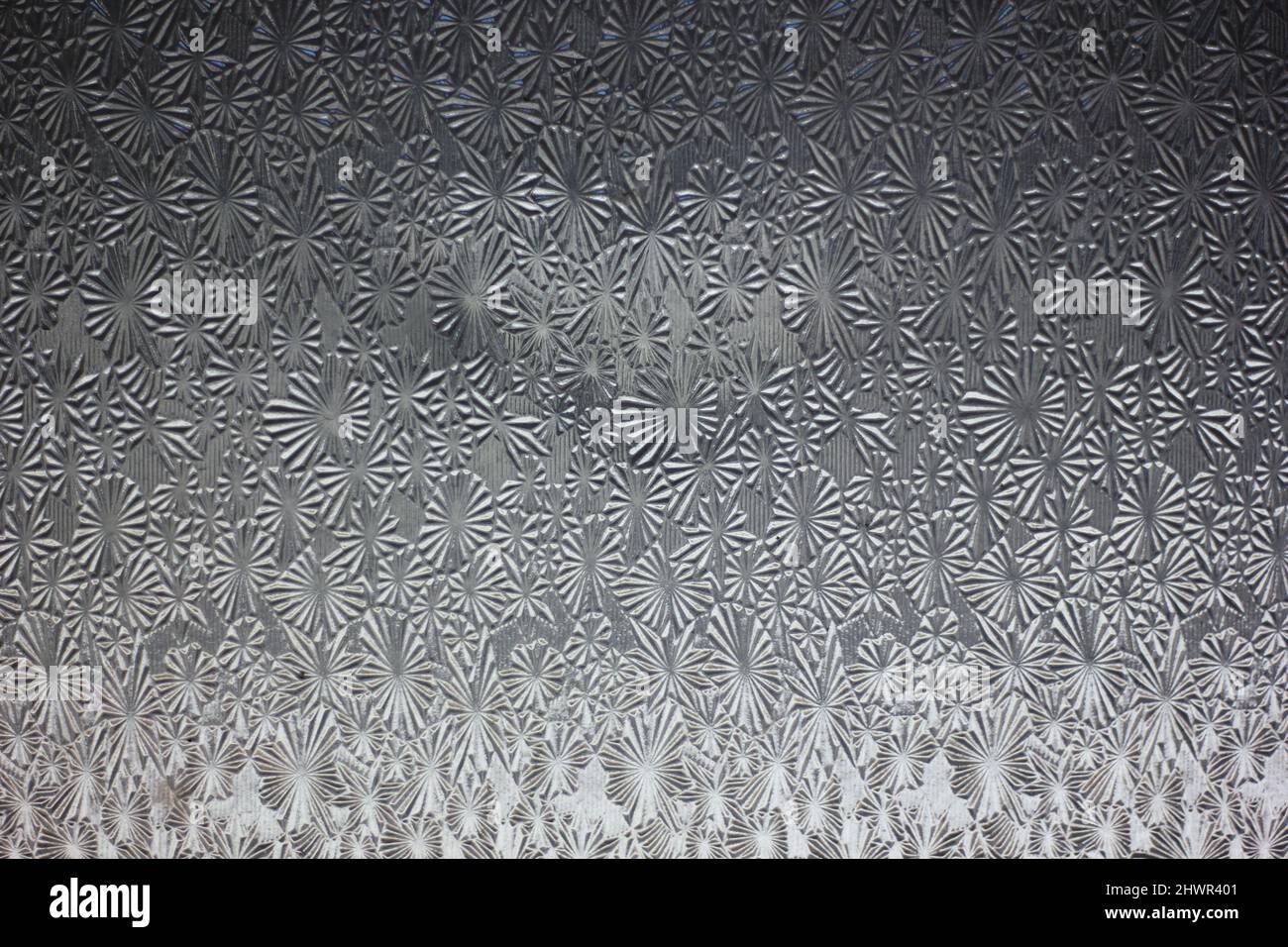 Interesting texture of an antique glass window with a floral pattern ...
