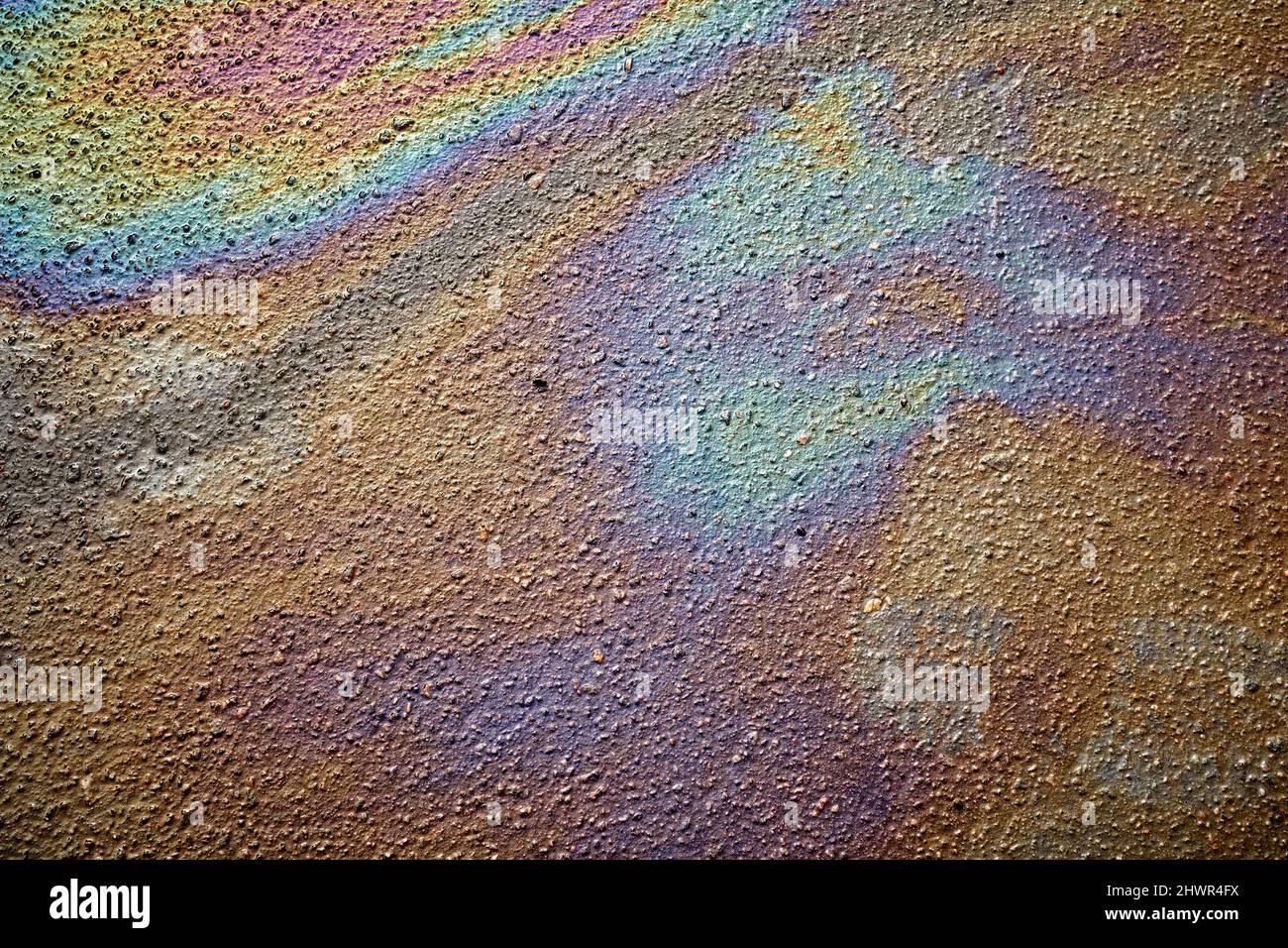 Abstract background from motor oil, gas or petrol spilled on asphalt ...