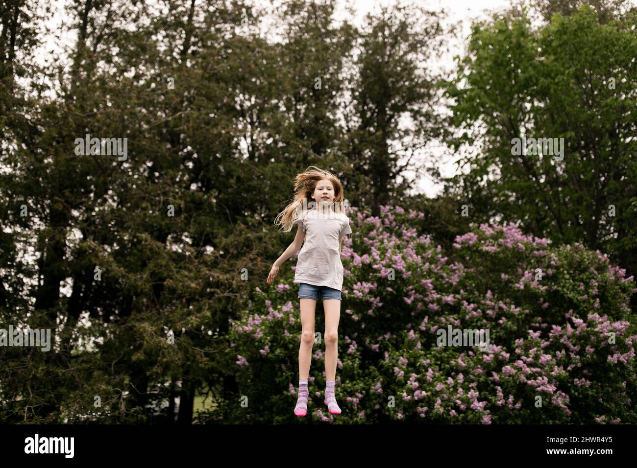 Cute girl jumping in nature Stock Photo - Alamy
