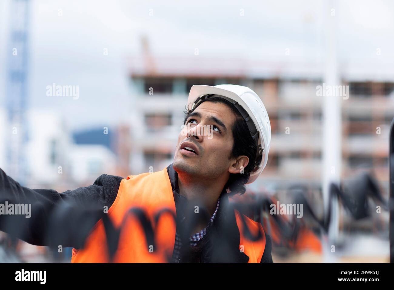 Engineer looking up working outdoors Stock Photo - Alamy