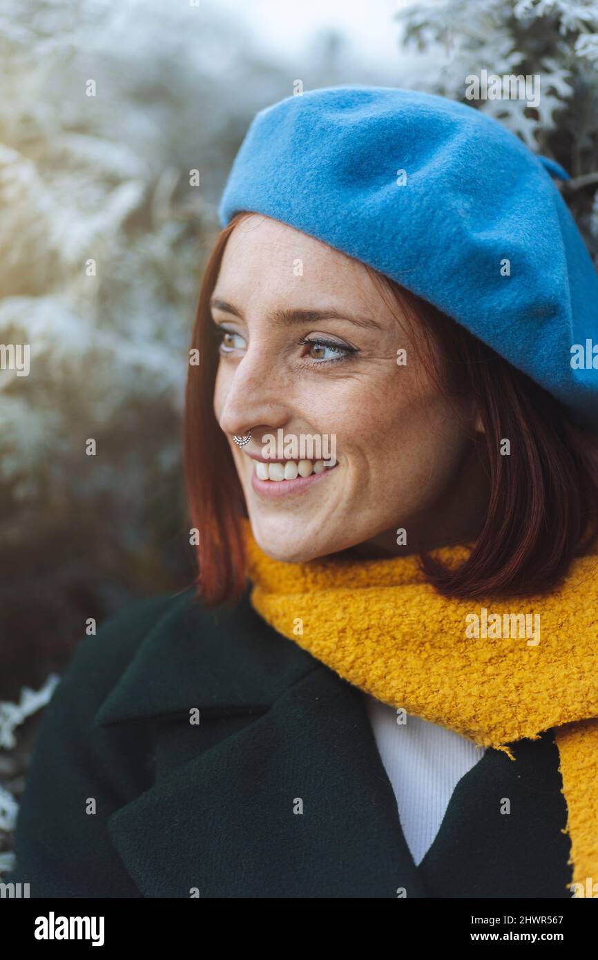 Happy redhead woman in blue beret and yellow scarf Stock Photo - Alamy