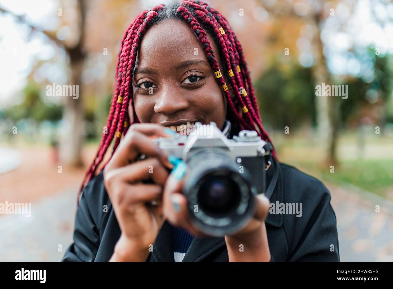 Young woman braids in red hi-res stock photography and images - Alamy