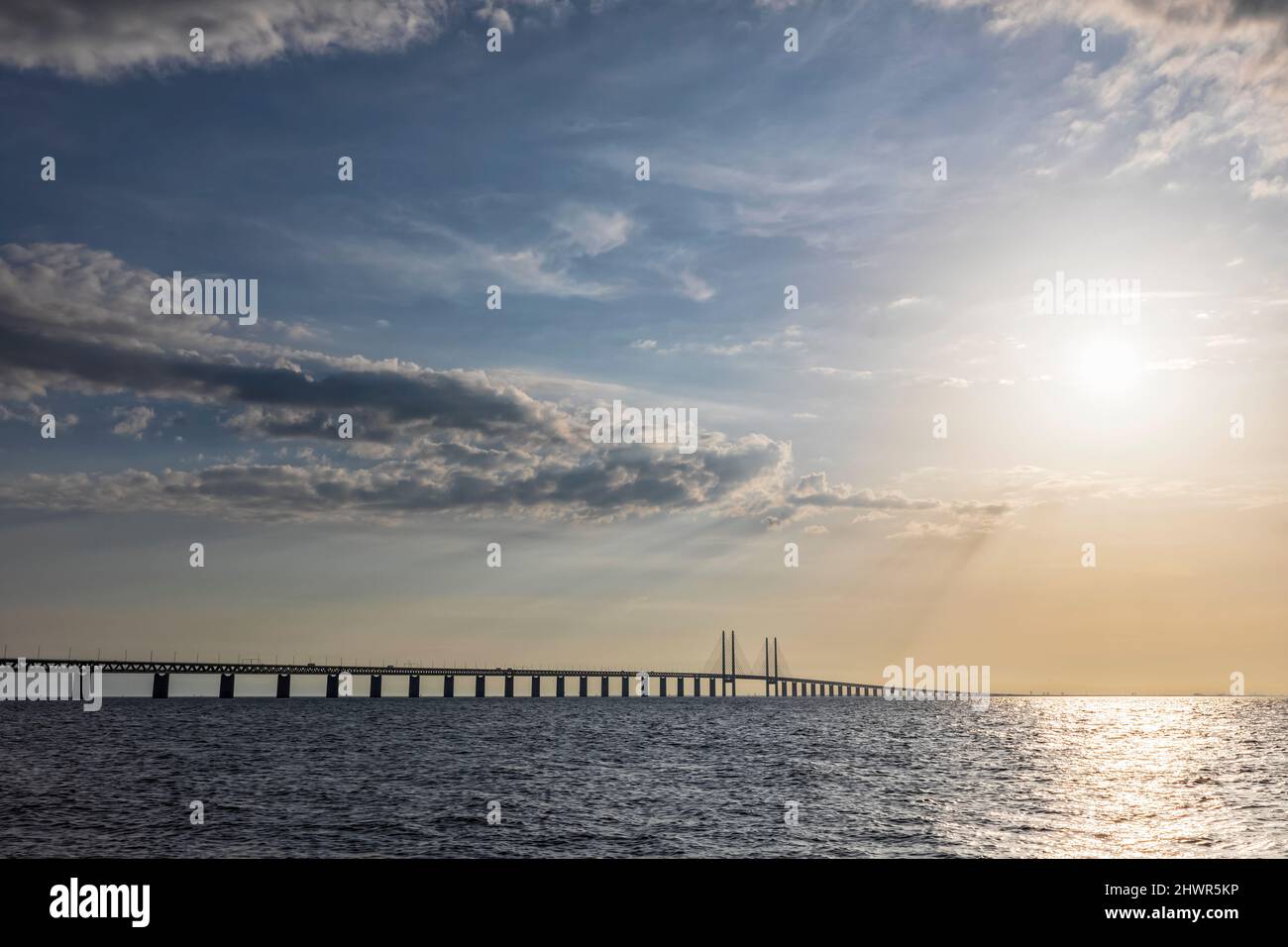Sound strait at sunset with silhouette of Oresund Bridge in background ...