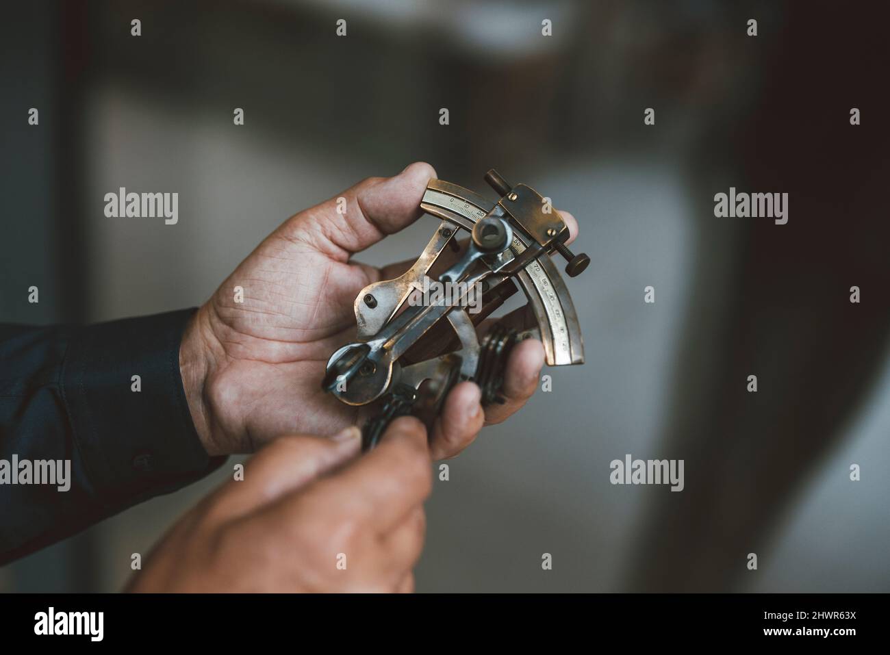 Senior man holding measuring tool Stock Photo - Alamy