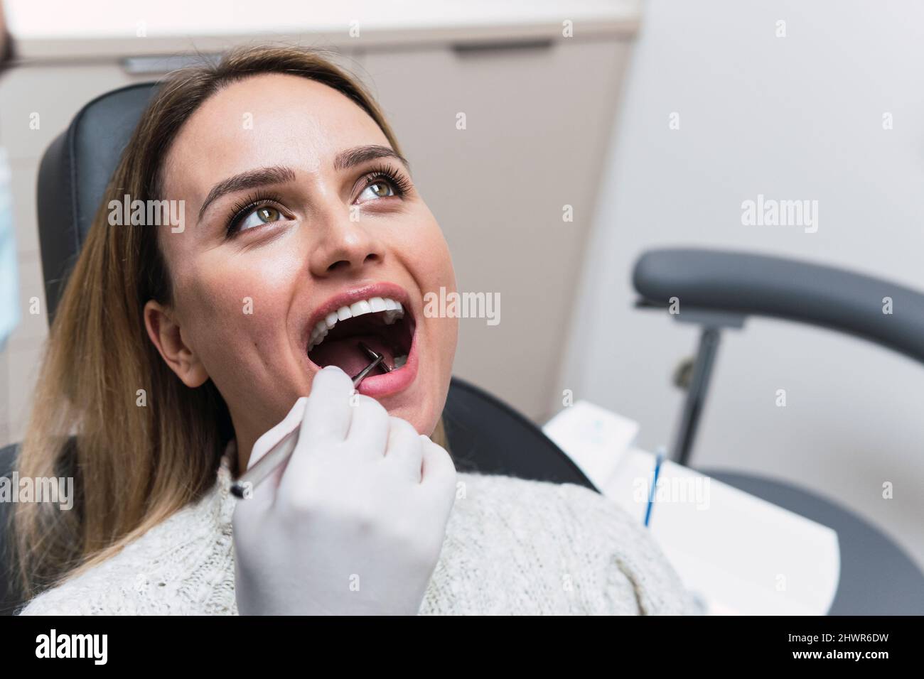 Dentist checking patient's teeth in medical room at clinic Stock Photo ...