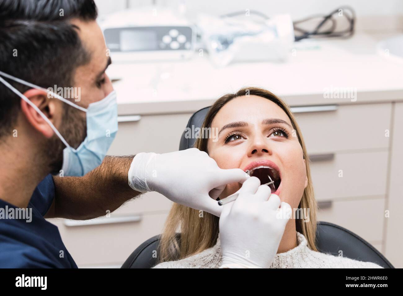 Dentist examining patient's teeth in clinic Stock Photo - Alamy