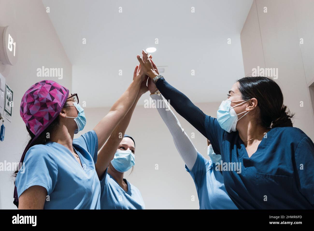 Doctors giving high-five to each other at hospital Stock Photo - Alamy
