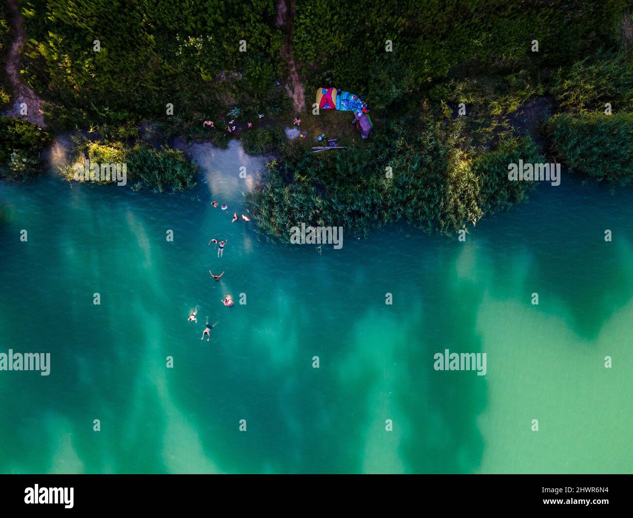 overhead view of leak beach blue water. people having fun swimming ...