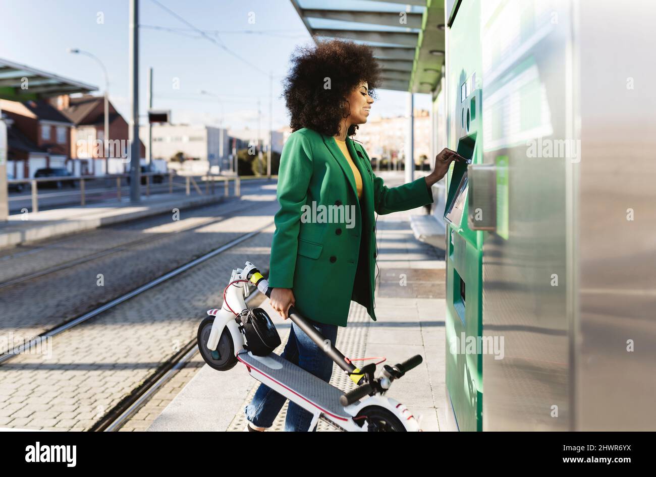 Commuter buying ticket from machine at tram station Stock Photo - Alamy