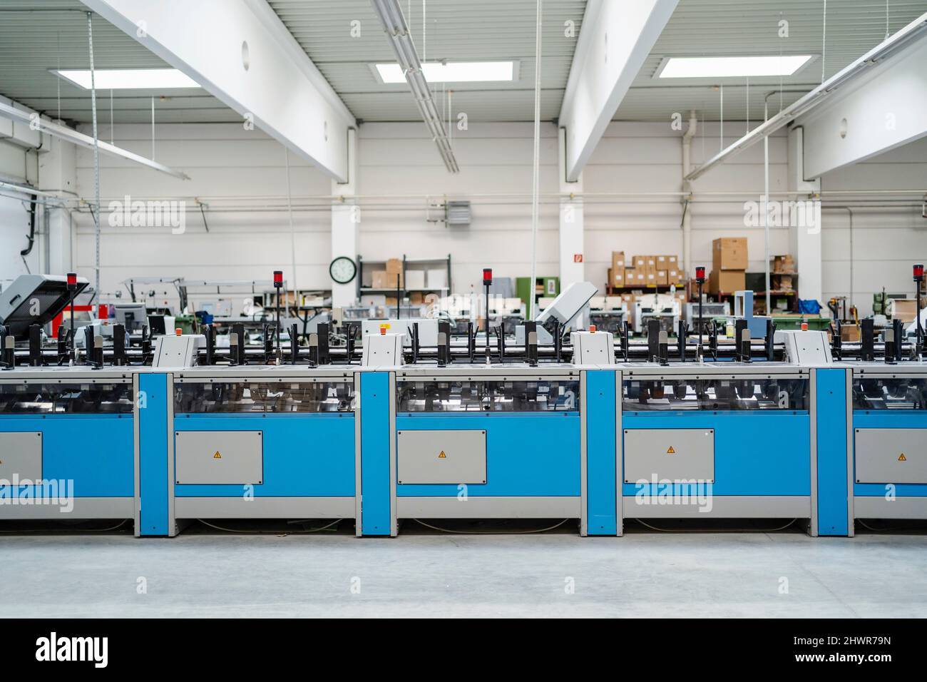 Blue machinery at illuminated production hall Stock Photo - Alamy
