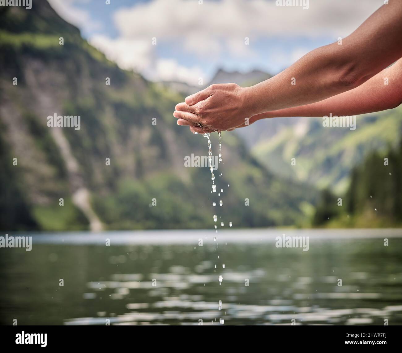 Water dropping from hands of woman Stock Photo - Alamy