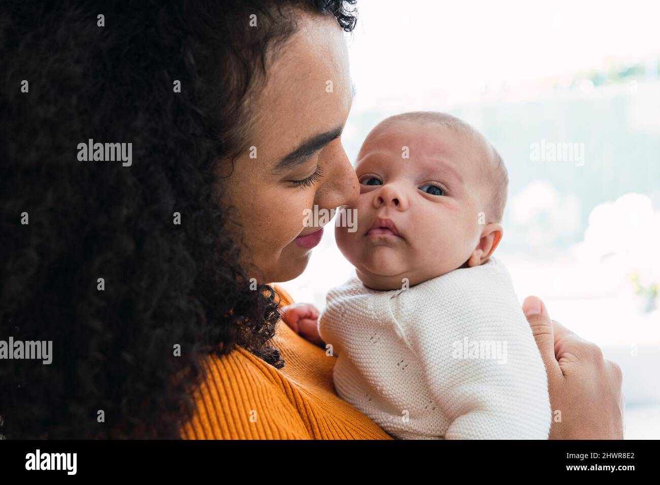Affectionate mother carrying baby boy Stock Photo - Alamy