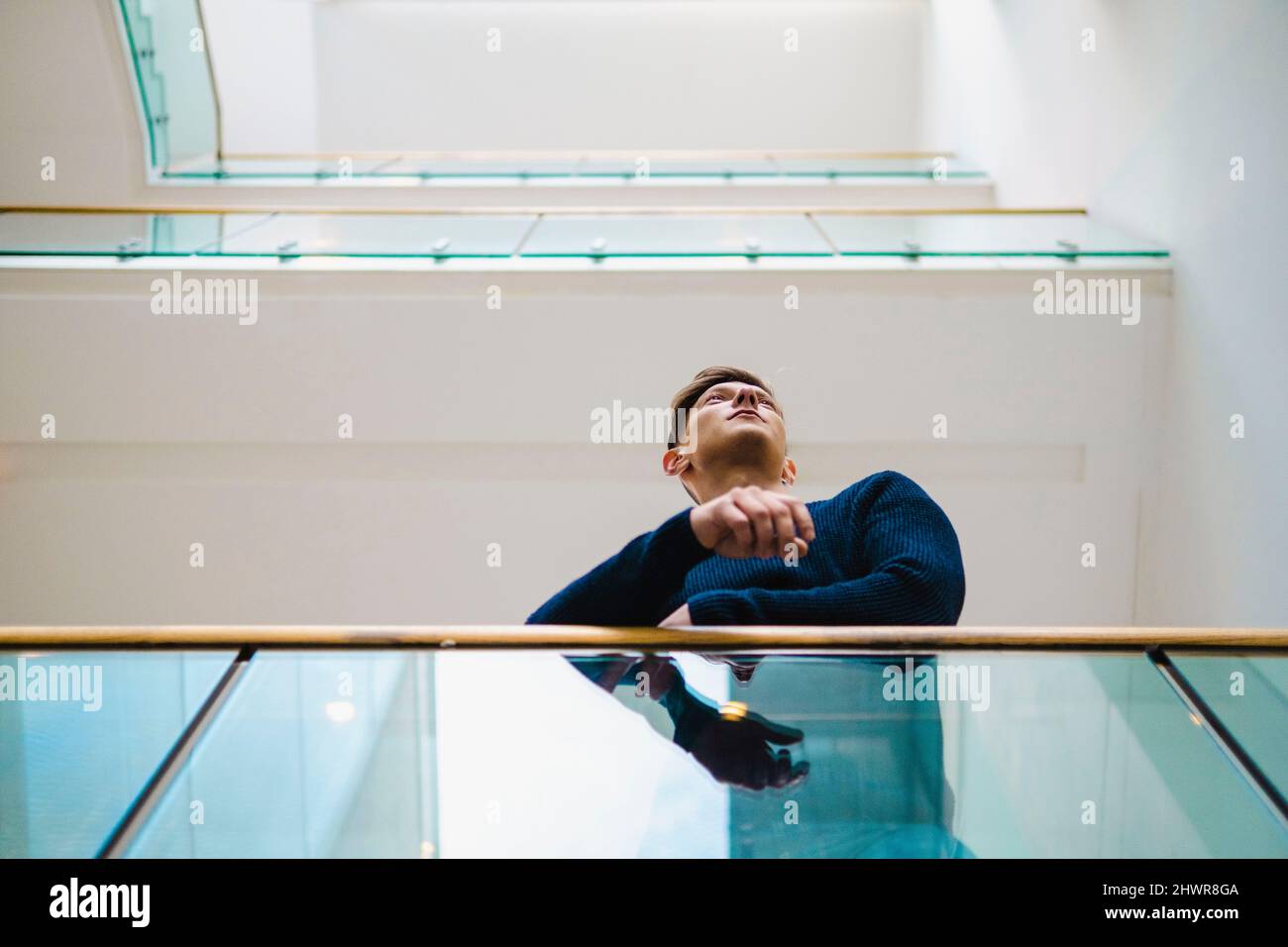 Young man leaning railing hi-res stock photography and images - Alamy
