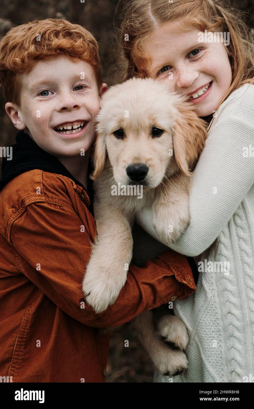 Happy family with puppy hi-res stock photography and images - Alamy