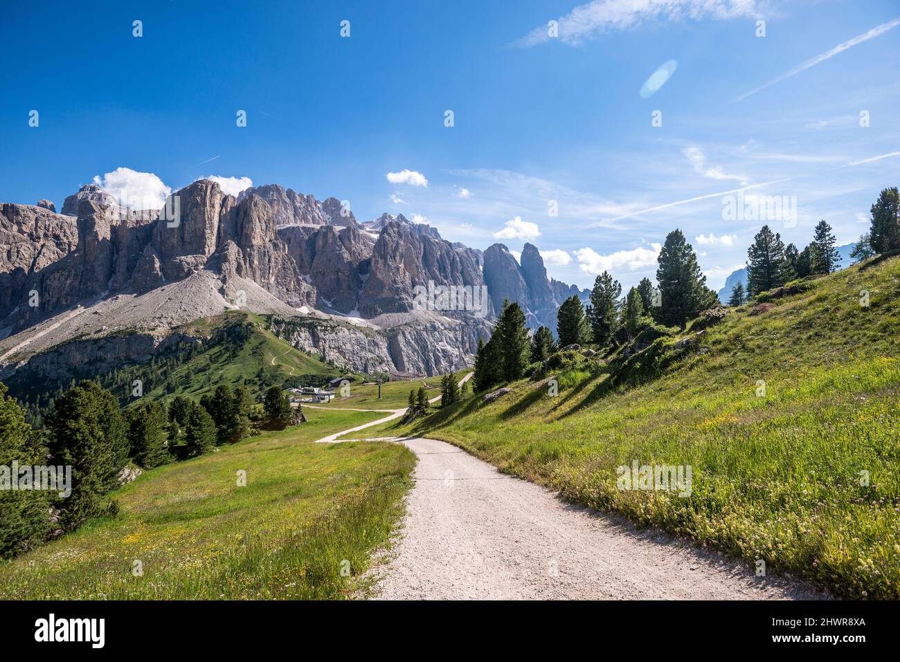 Italy, South Tyrol, Dirt road in Gardena Pass with Sella Group massif ...