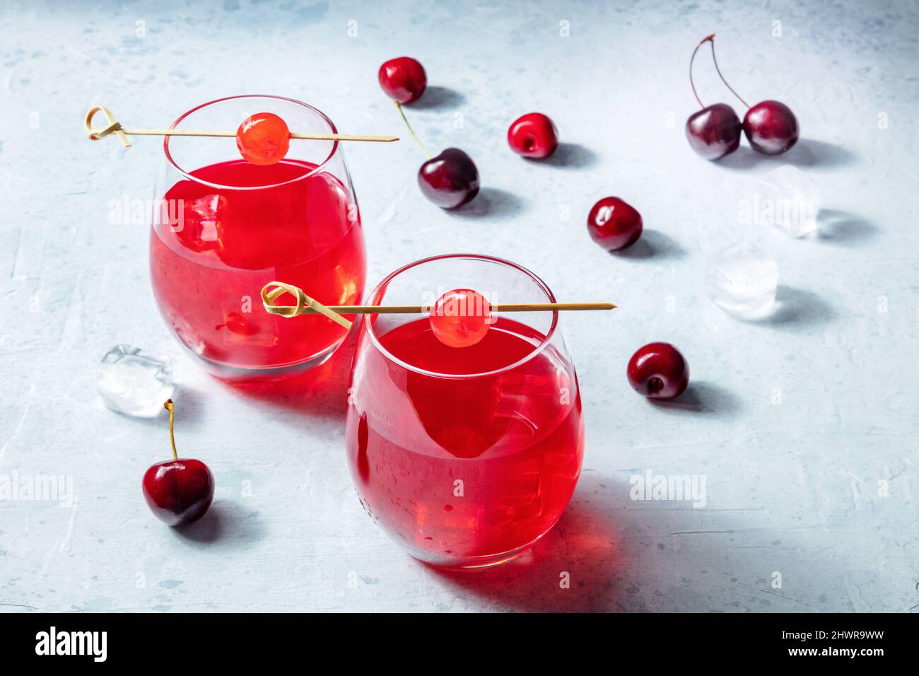 Cocktail cherries and mocktails, a vibrant red drink with ice, cold ...