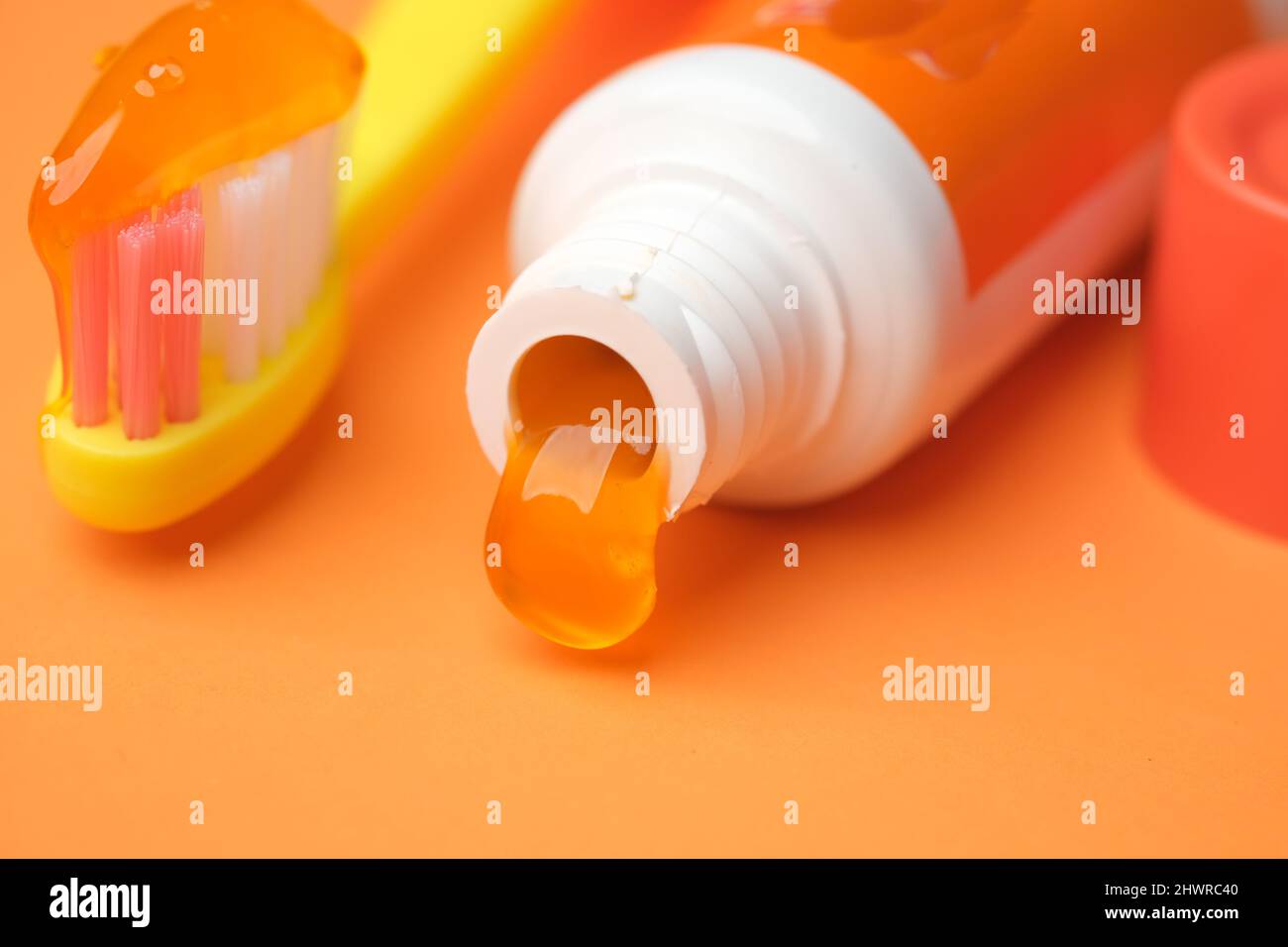 orange color child tooth brush with paste Stock Photo - Alamy