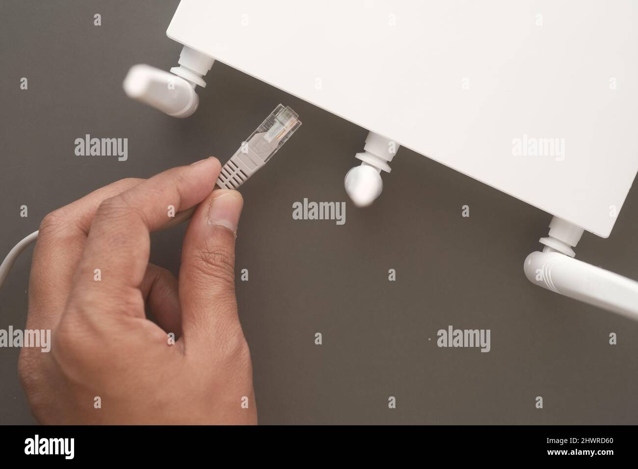 Wi-Fi router with cables on table Stock Photo - Alamy