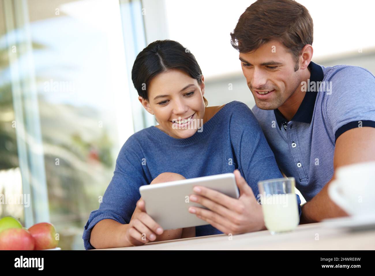 Lunch-time digital dates. Cropped shot of an affectionate couple using ...