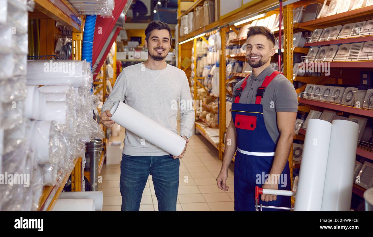 Happy young man shopping for ventilation pipes for his house at a ...