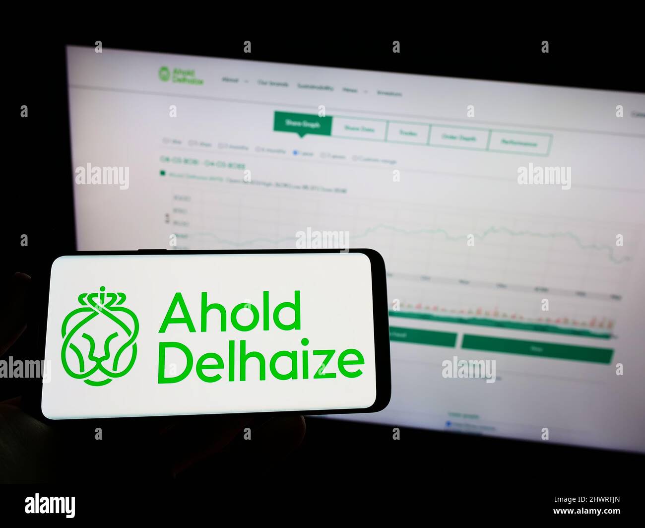 Person holding cellphone with logo of Dutch company Koninklijke Ahold ...