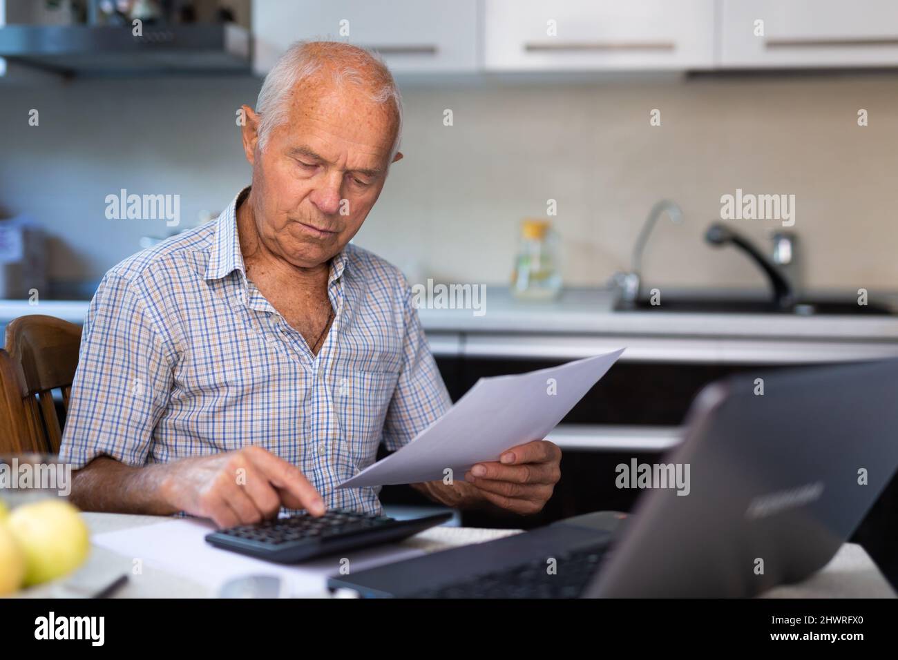 Old man calculating paper hi-res stock photography and images - Alamy