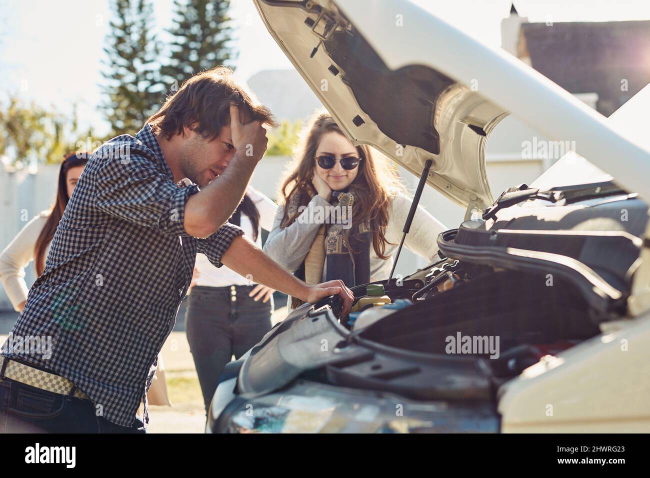 Man looking under car hood of broken down car hi-res stock photography ...