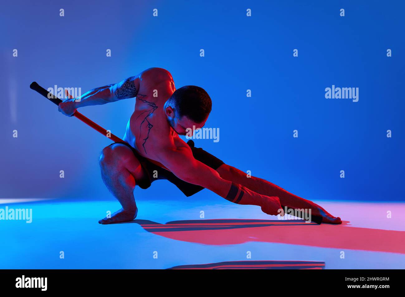 athlete men with stick training karate using sports tool in studio on ...