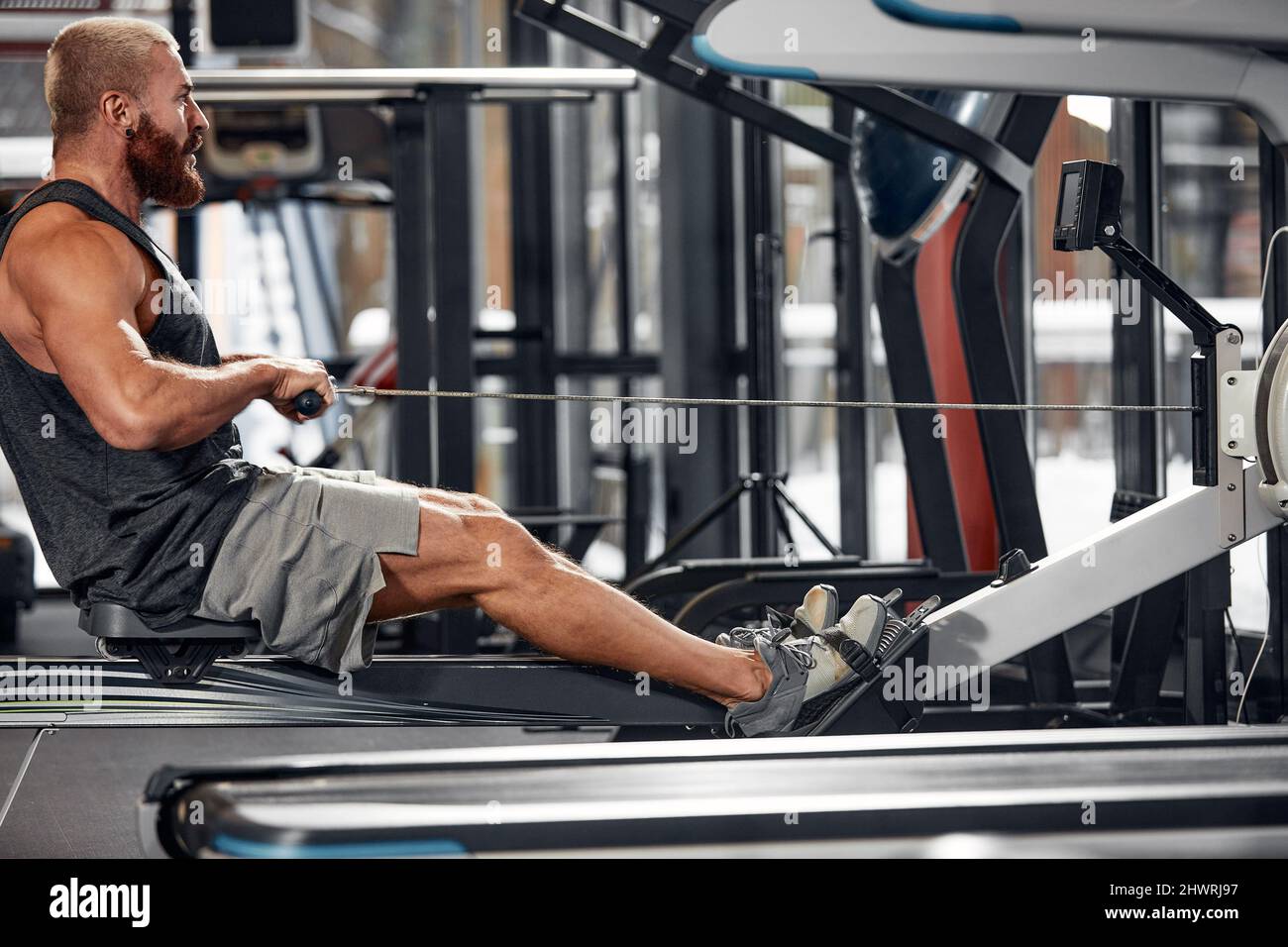 Training legs in the simulator, the athlete works with his legs on the ...