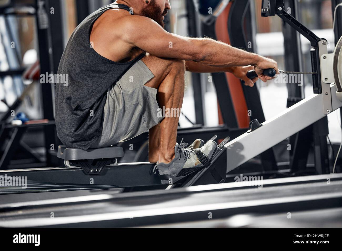 Training legs in the simulator, the athlete works with his legs on the ...