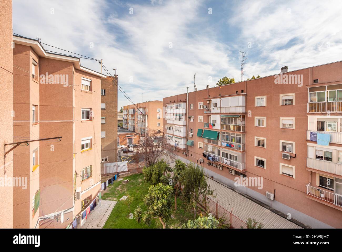 Facades of residential apartment buildings with a garden between them ...