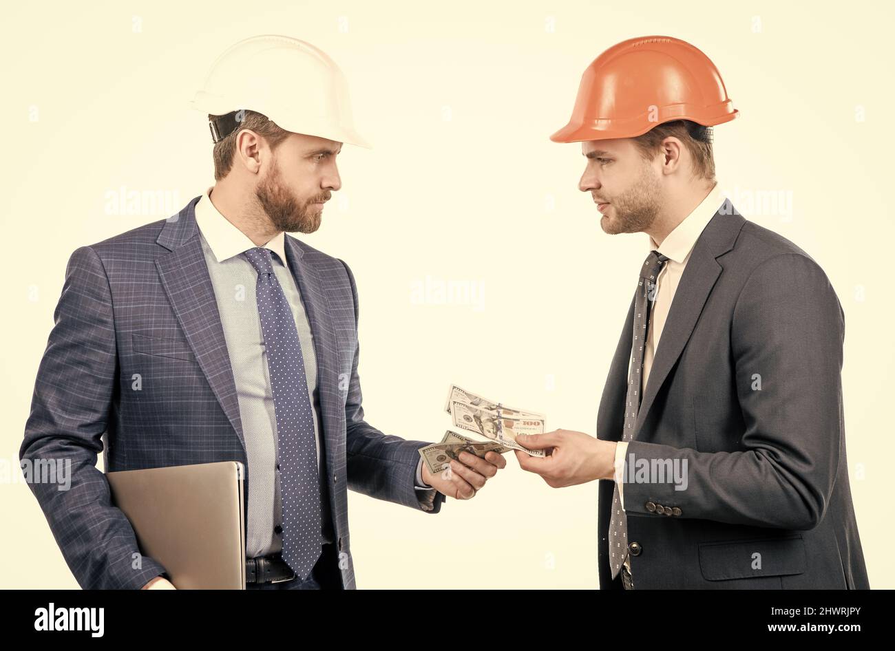 investors men in suit and safety helmet giving or taking money and hold ...