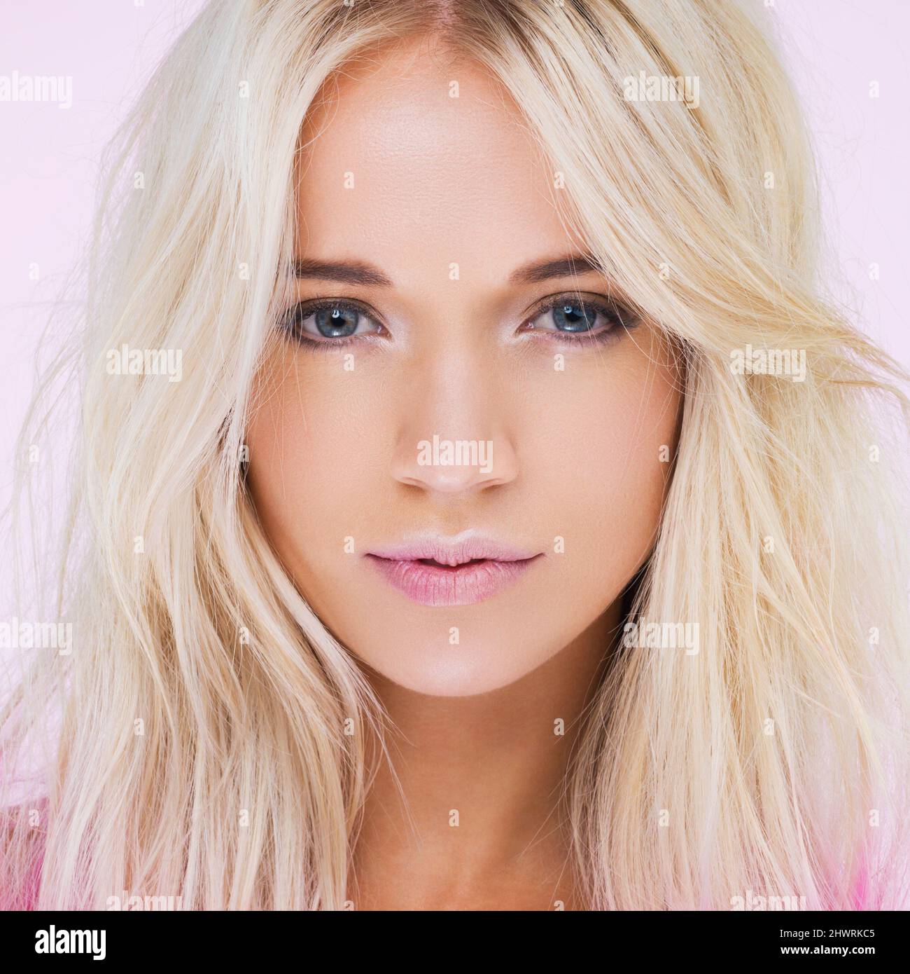 Pretty in pink. Studio portrait of a beautiful young woman posing ...