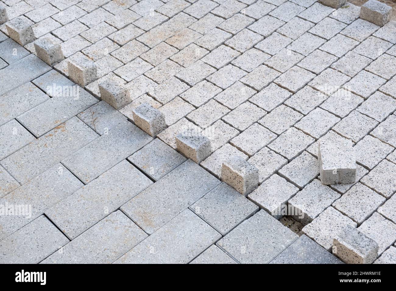 Industrial construction site laying cobblestones Belgian blocks and ...