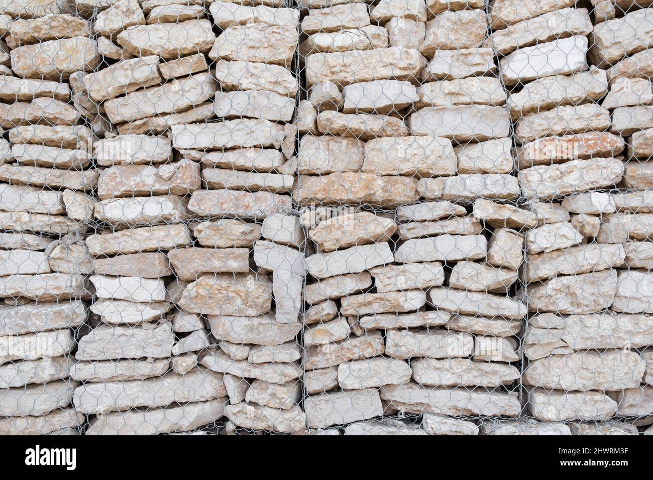 Lime stones in Rabitz Wire Mesh Basket Gabion Wall, fence filled with ...