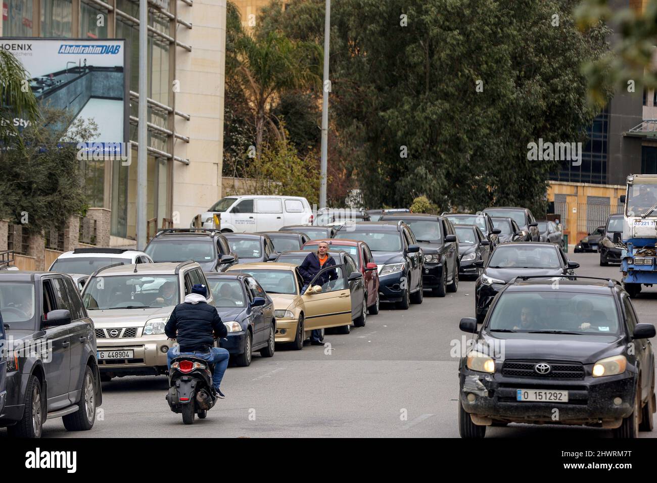 07 March 2022, Lebanon, Beirut: Cars line up in front of a local petrol ...