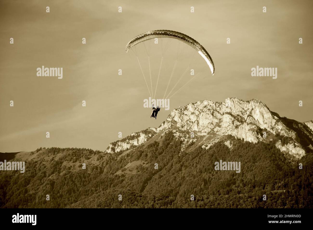 Paragliders flying in tandem and mountains of Savoy at background ...