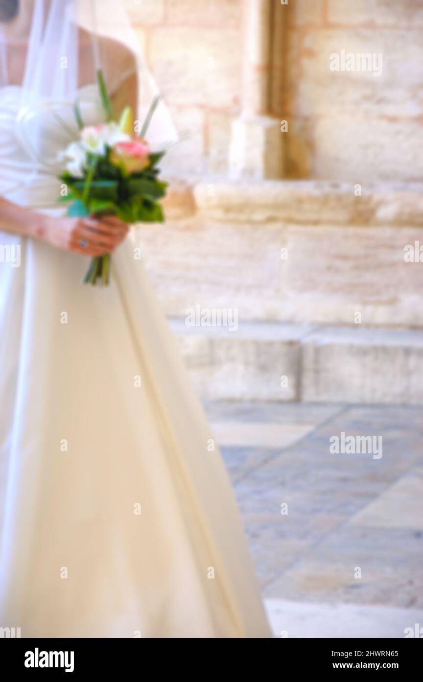 Blurry photo of the bride before entering the church on her wedding day ...