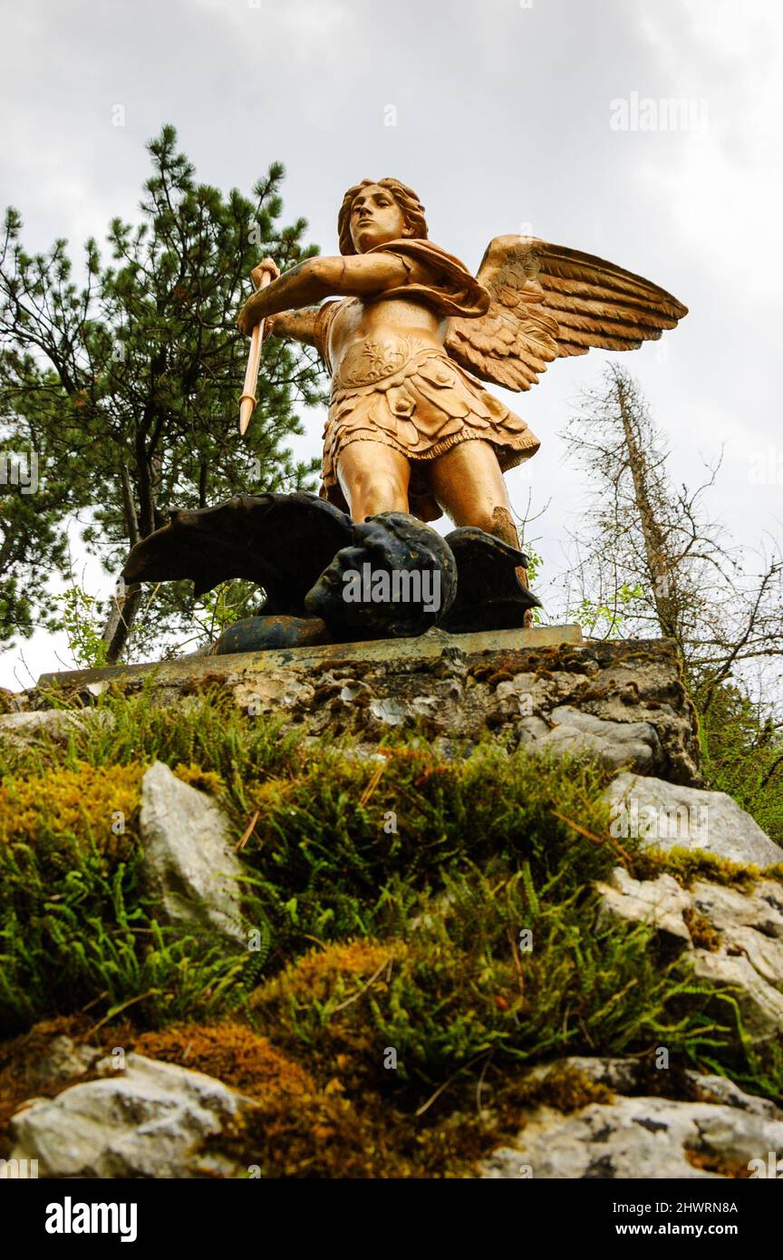 Saint Michael defeats Satan. Park sculpture in Annecy lake area. Duingt ...