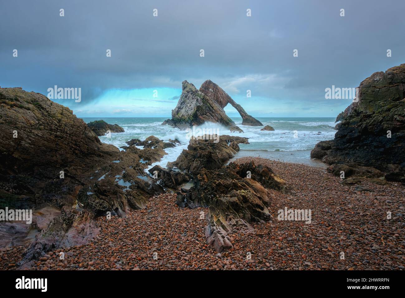 Amazing view of the sea cliffs, in the shape of an arch and stones in ...