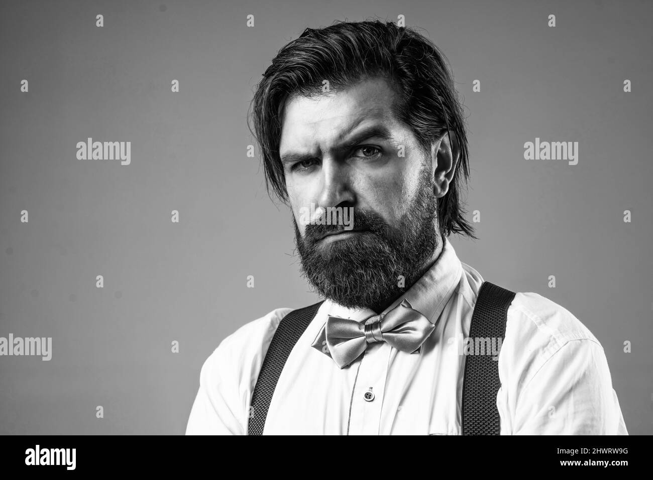 real gentleman. trendy man in suspenders and bow tie. confident and ...