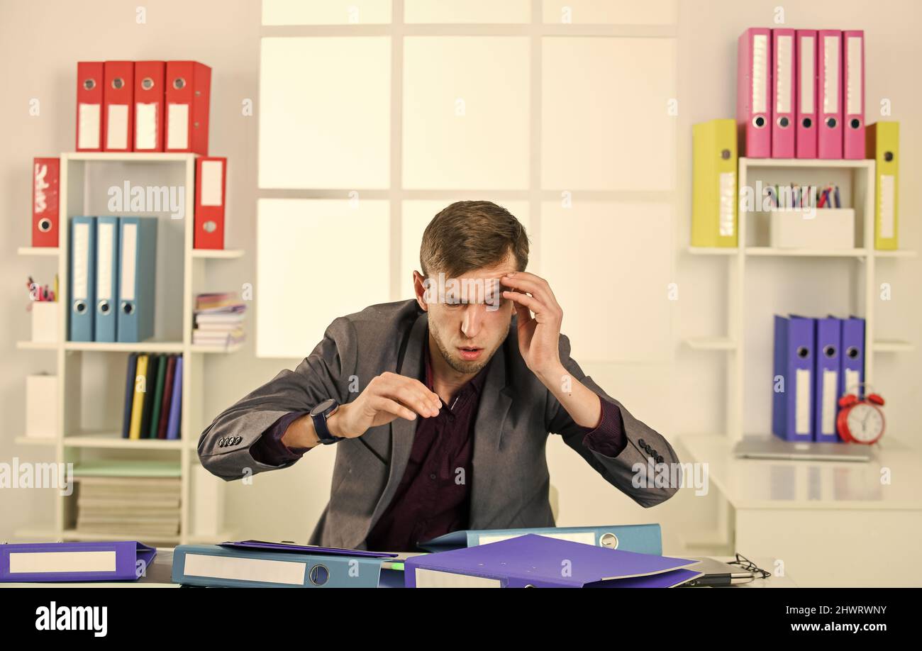 businessman working in office with headache. male manager work on ...
