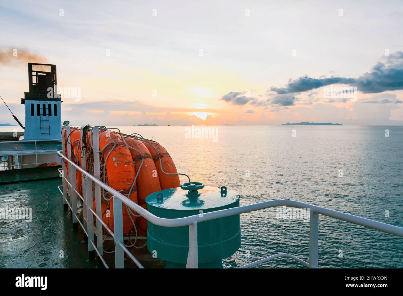 Orange inflatable lifeboats on ferry deck for emergencies and maritime ...
