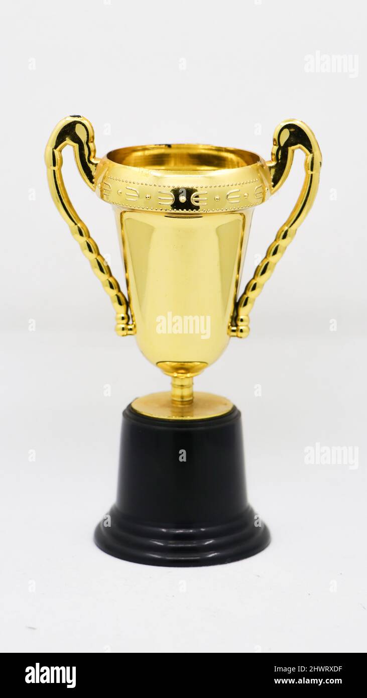 a vintage gold trophy prize cup, symmetrically designed isolated in a ...