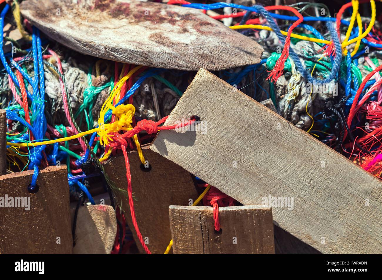 Many suspended chaotically intertwined colorful ropes tied into messy ...
