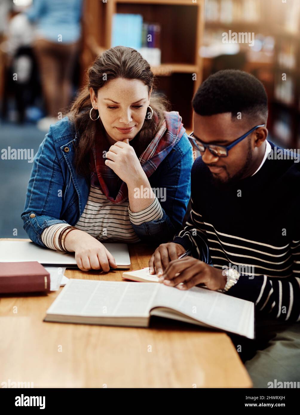 Turn to the next page. Shot of a group of university students working ...