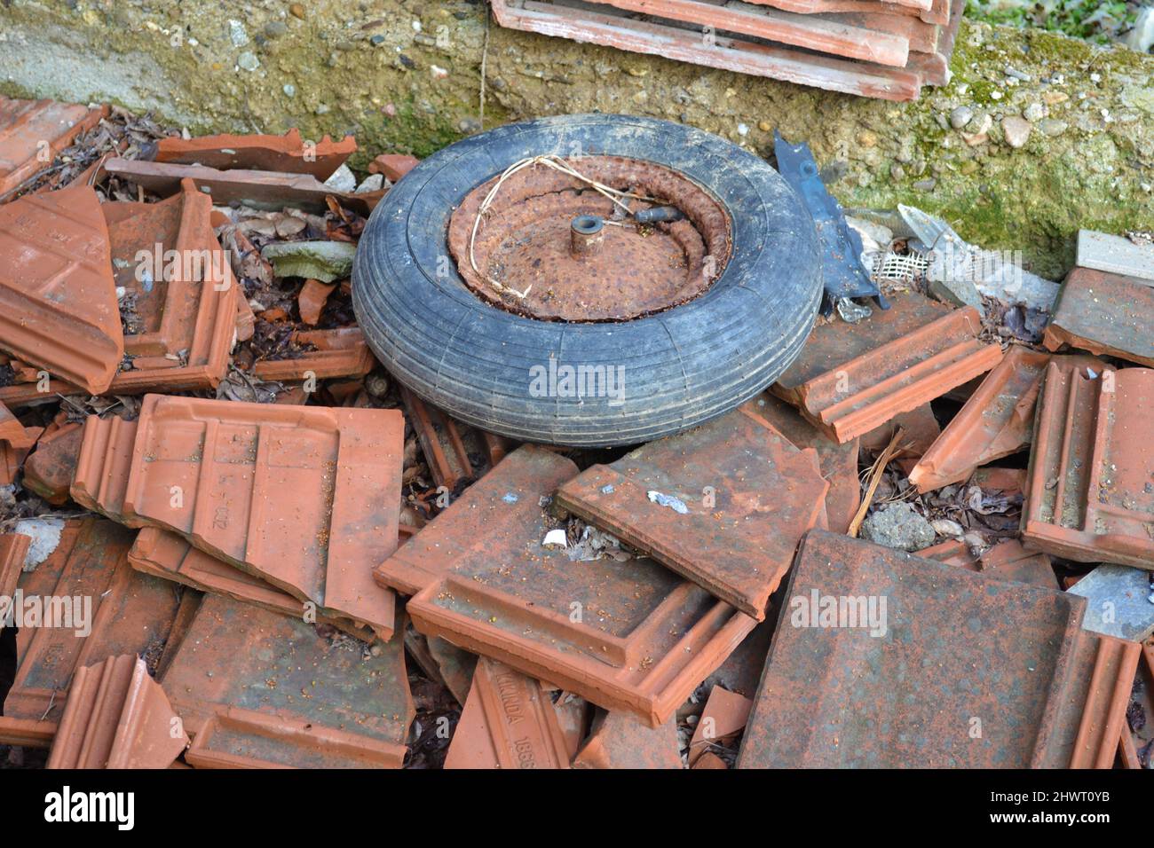 Old handcart tire and broken tiles Stock Photo - Alamy